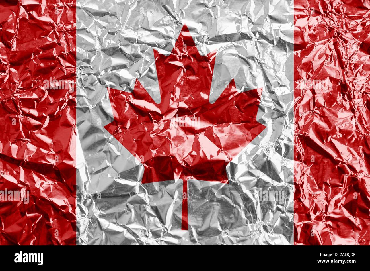Canada flag depicted in paint colors on shiny crumpled aluminium foil ...