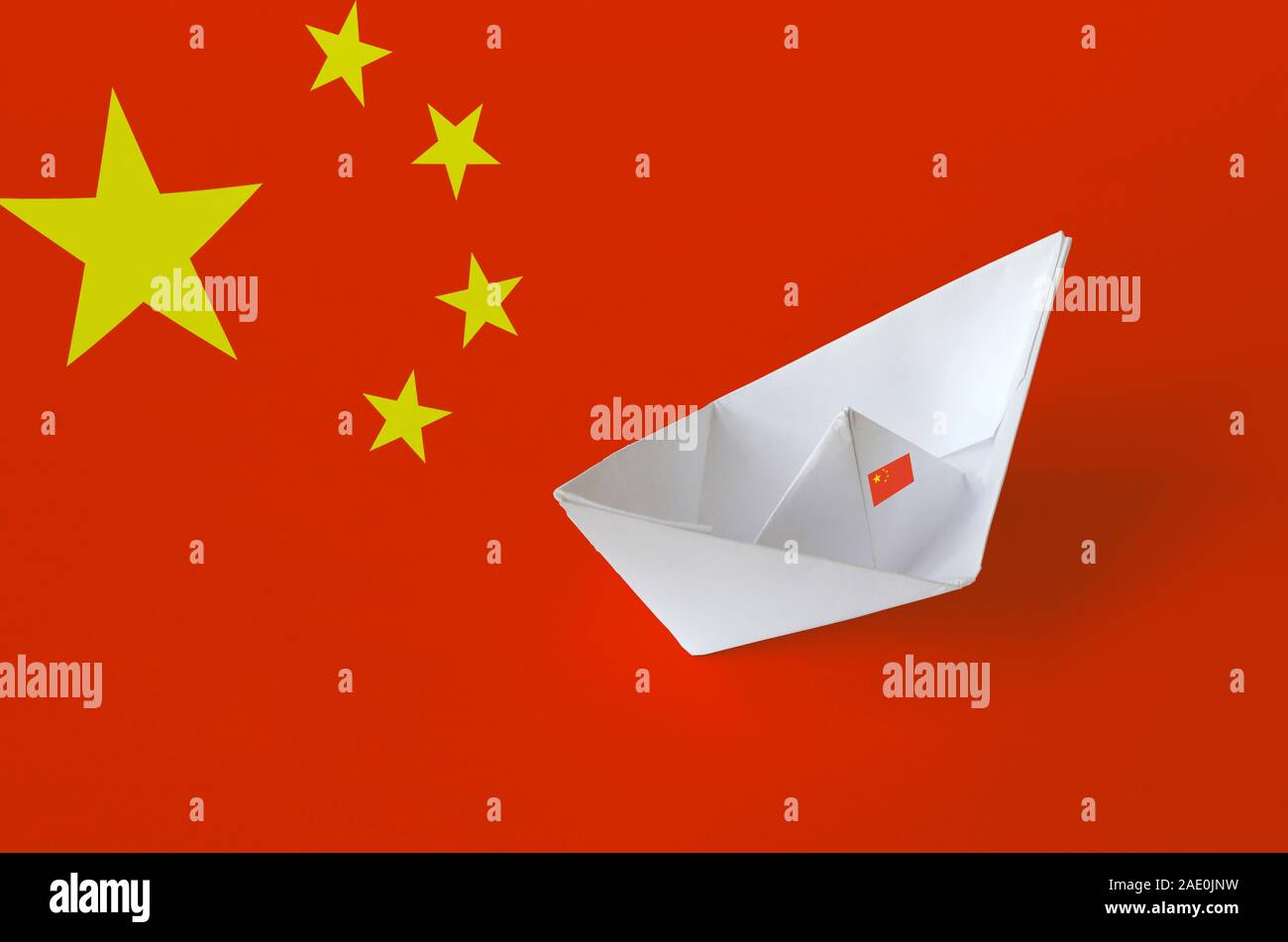 China flag depicted on paper origami ship closeup. Oriental handmade ...