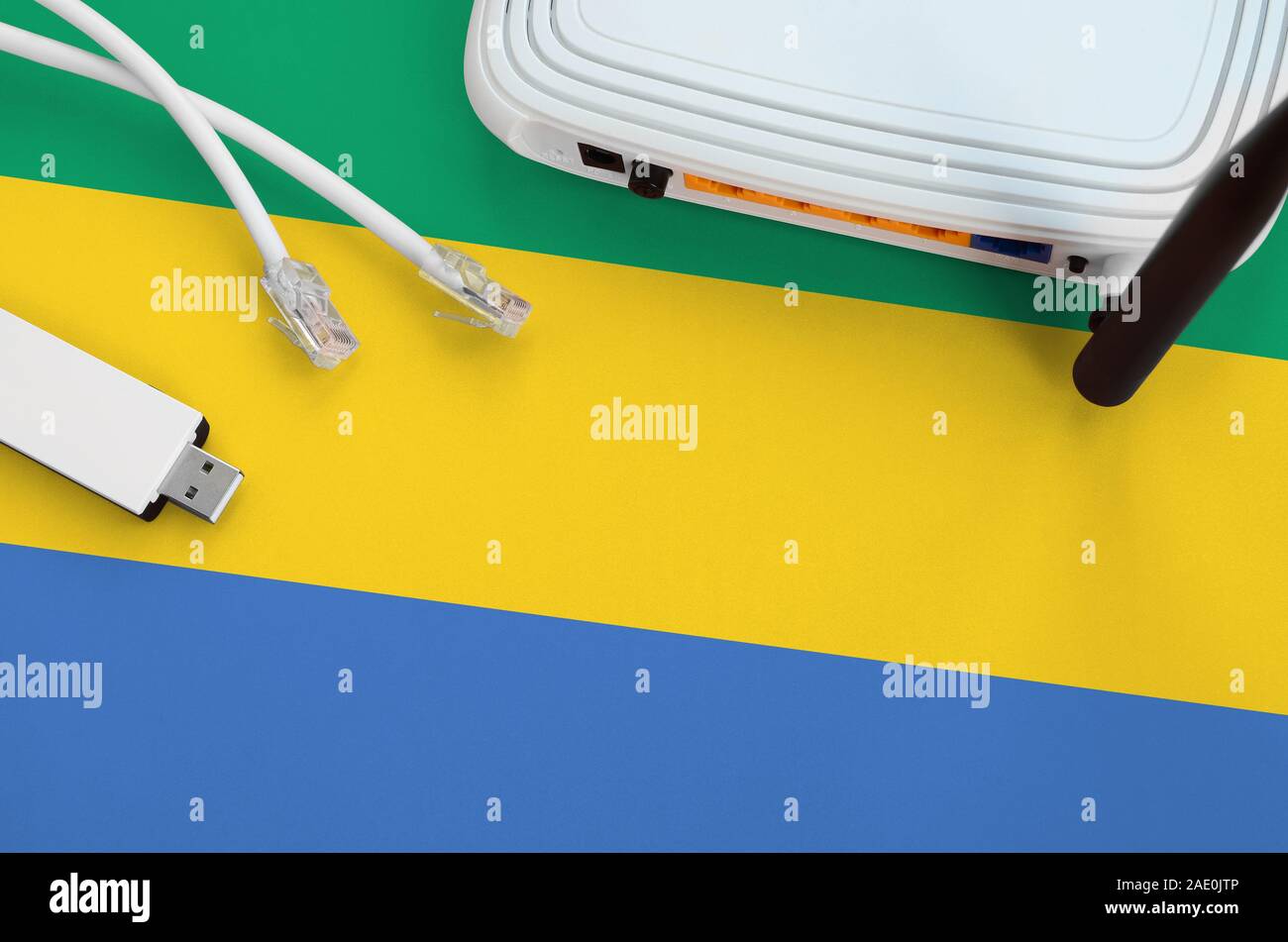 Gabon flag depicted on table with internet rj45 cable, wireless usb wi ...