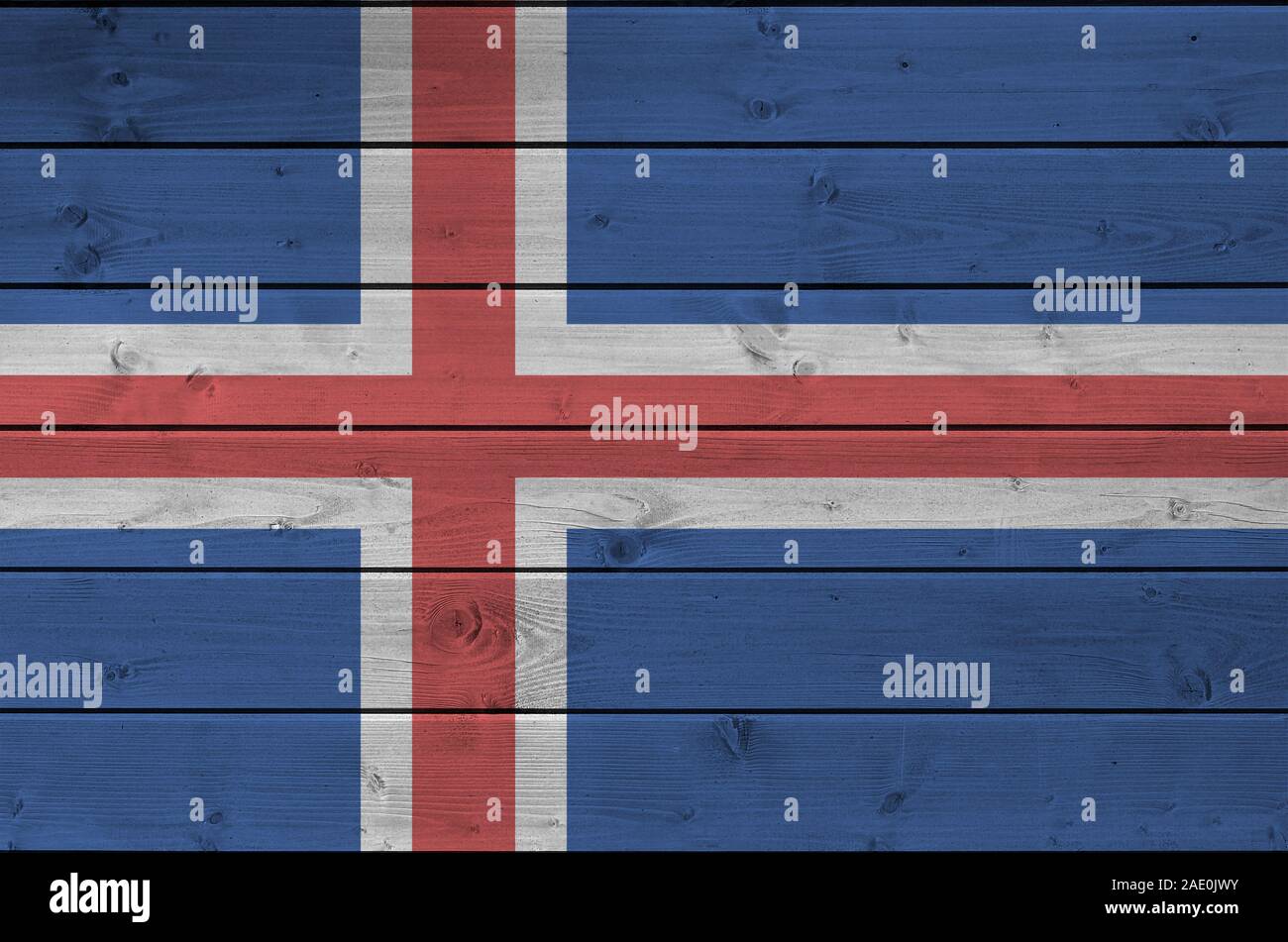 Iceland flag depicted in bright paint colors on old wooden wall close ...