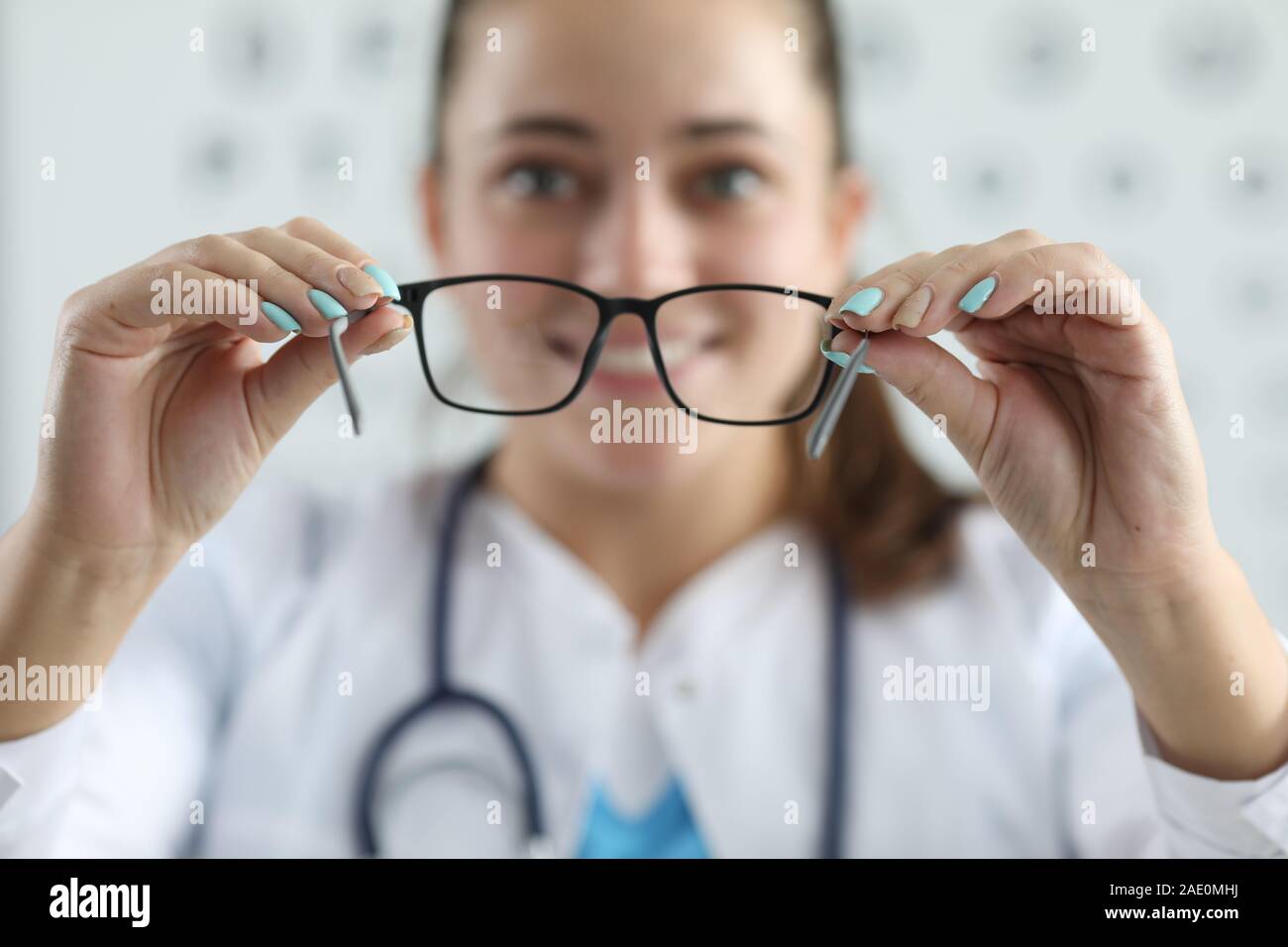 Happy female performing eyesight check Stock Photo - Alamy