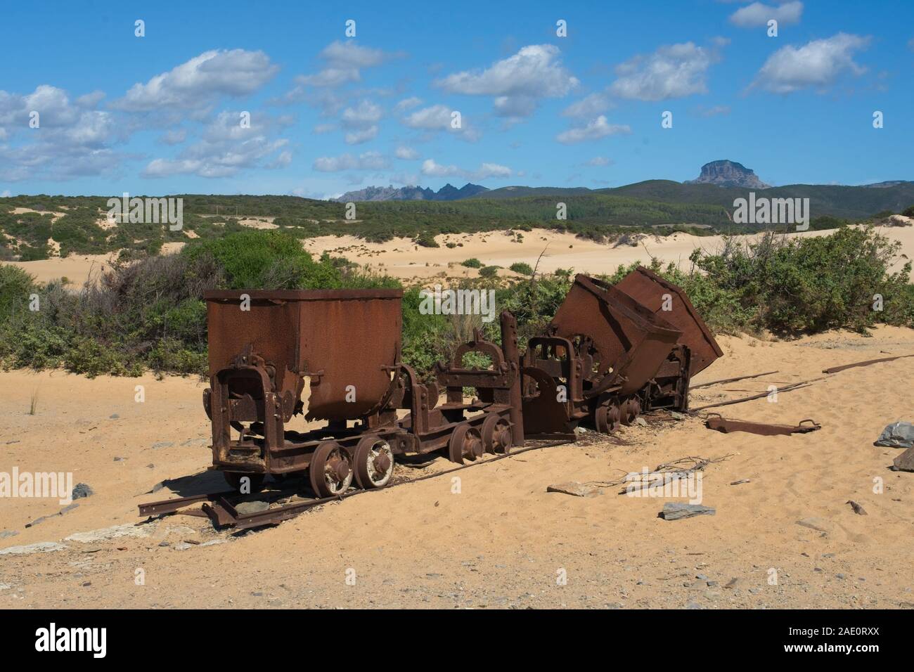 Rusty mining carts at beach of Spiaggia di Piscinas, Sardinia, Italy ...