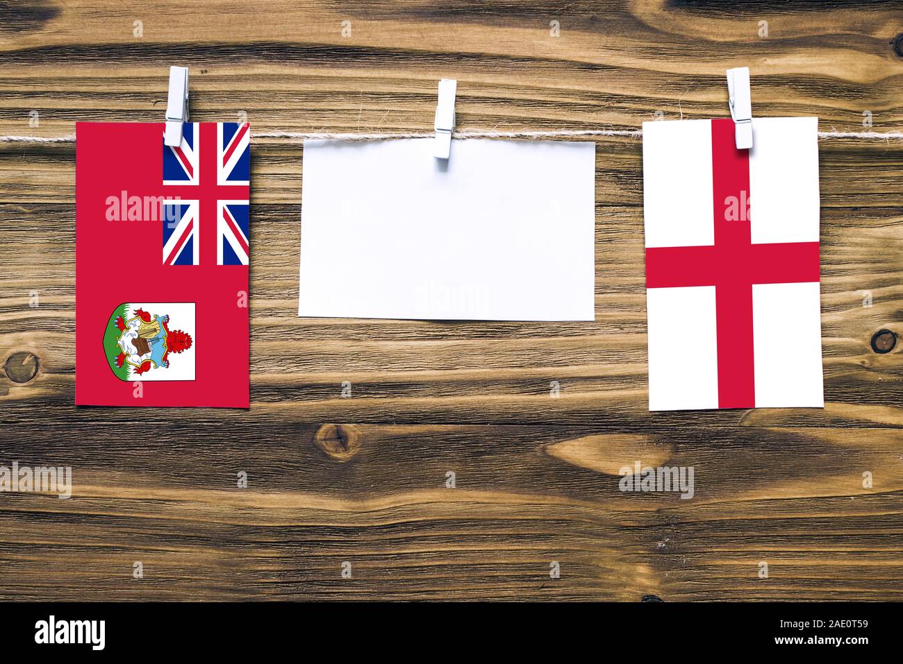 Hanging flags of Bermuda and England attached to rope with clothes pins ...