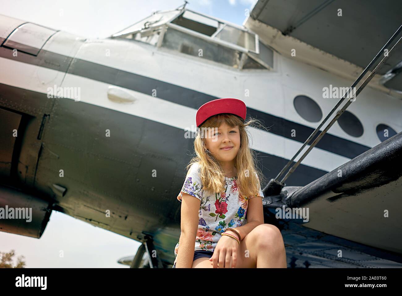 little girl sitting at the plane Stock Photo - Alamy