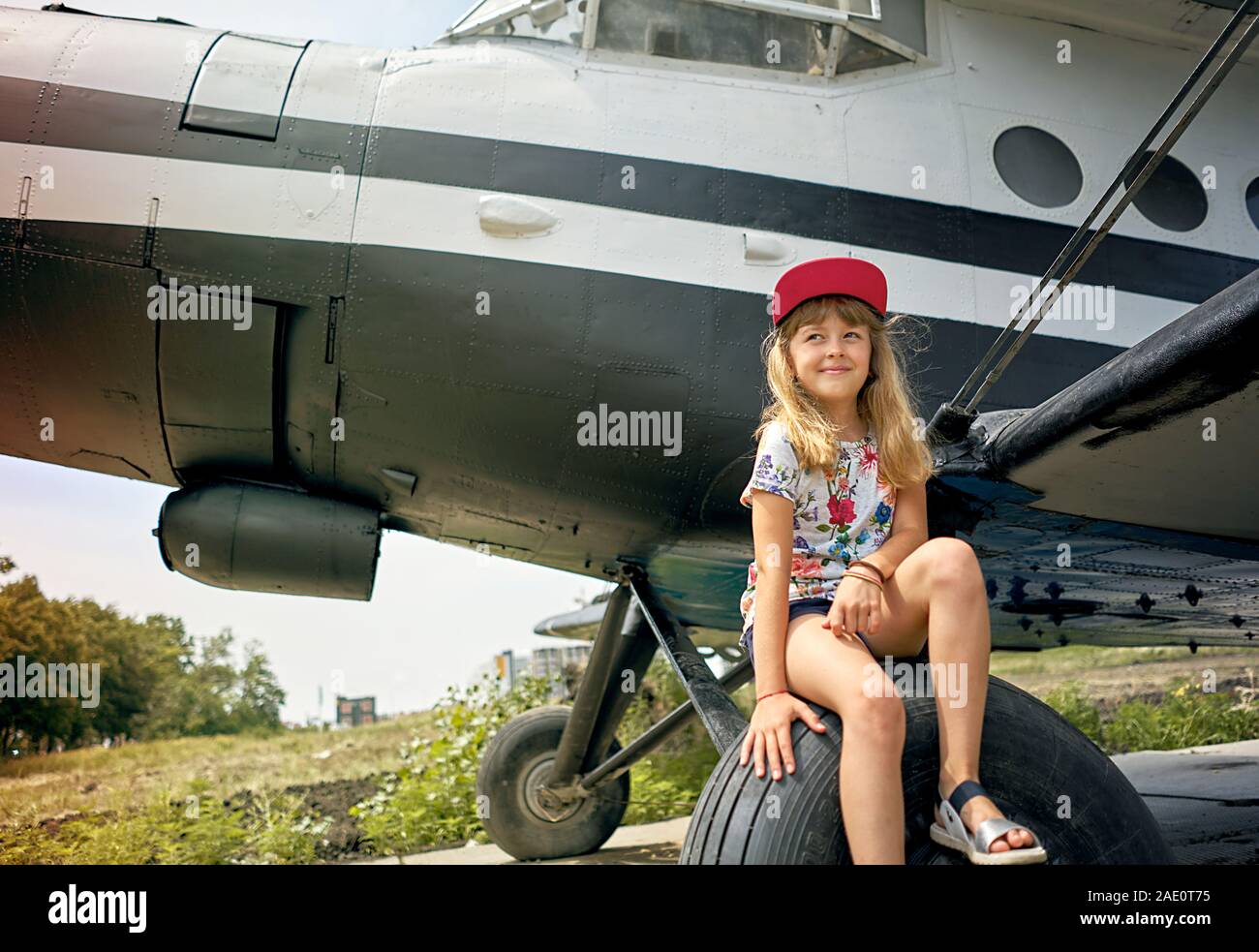 little girl sitting at the plane Stock Photo - Alamy