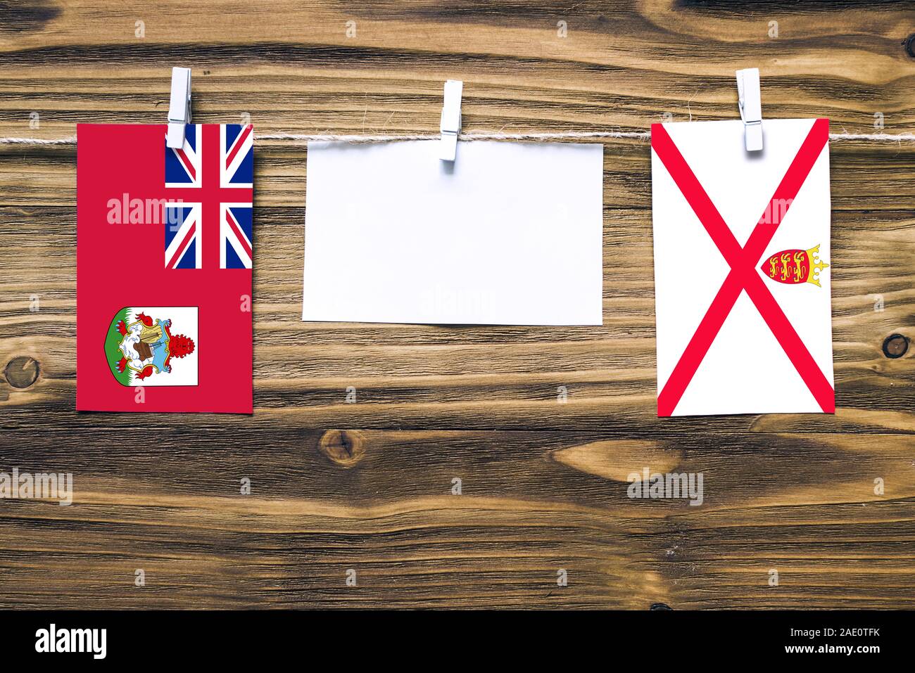 Hanging flags of Bermuda and Jersey attached to rope with clothes pins ...