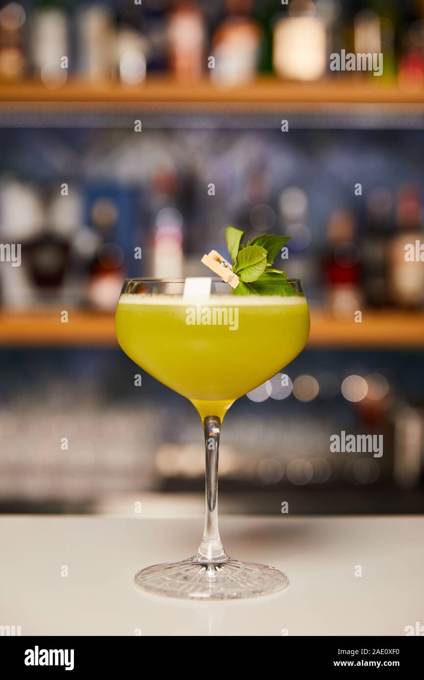 glass with mixed alcohol cocktail on bar counter Stock Photo - Alamy
