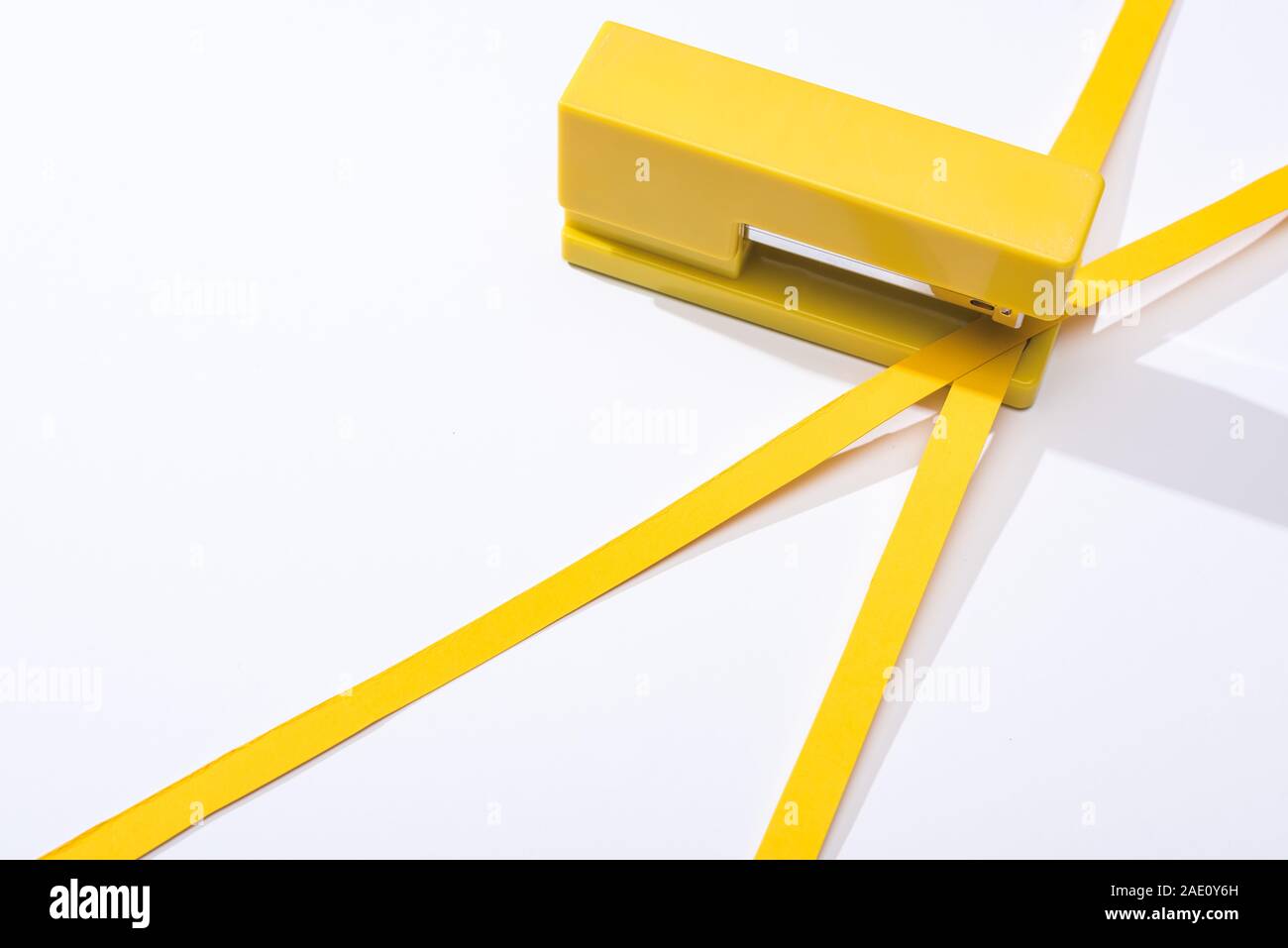 high angle view of stapler and paper strips on white background Stock ...
