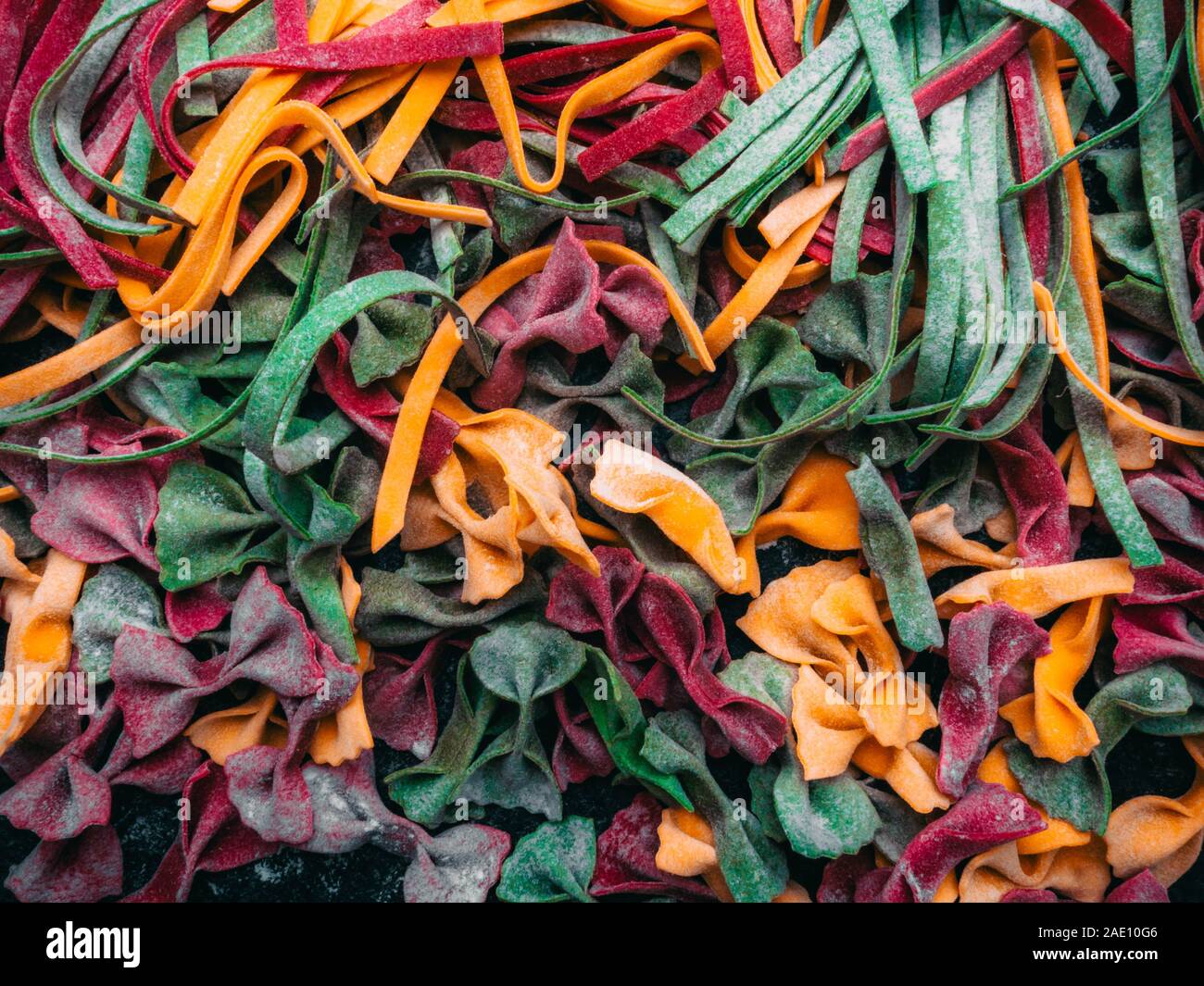 Homemade pasta, farfalle bow-tie, fettuccine or tagliatelle colorful ...