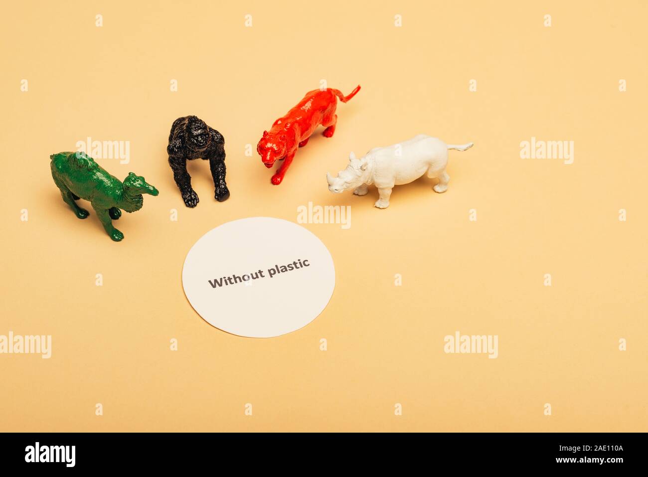 Colored toy animals with lettering without plastic on card on yellow ...