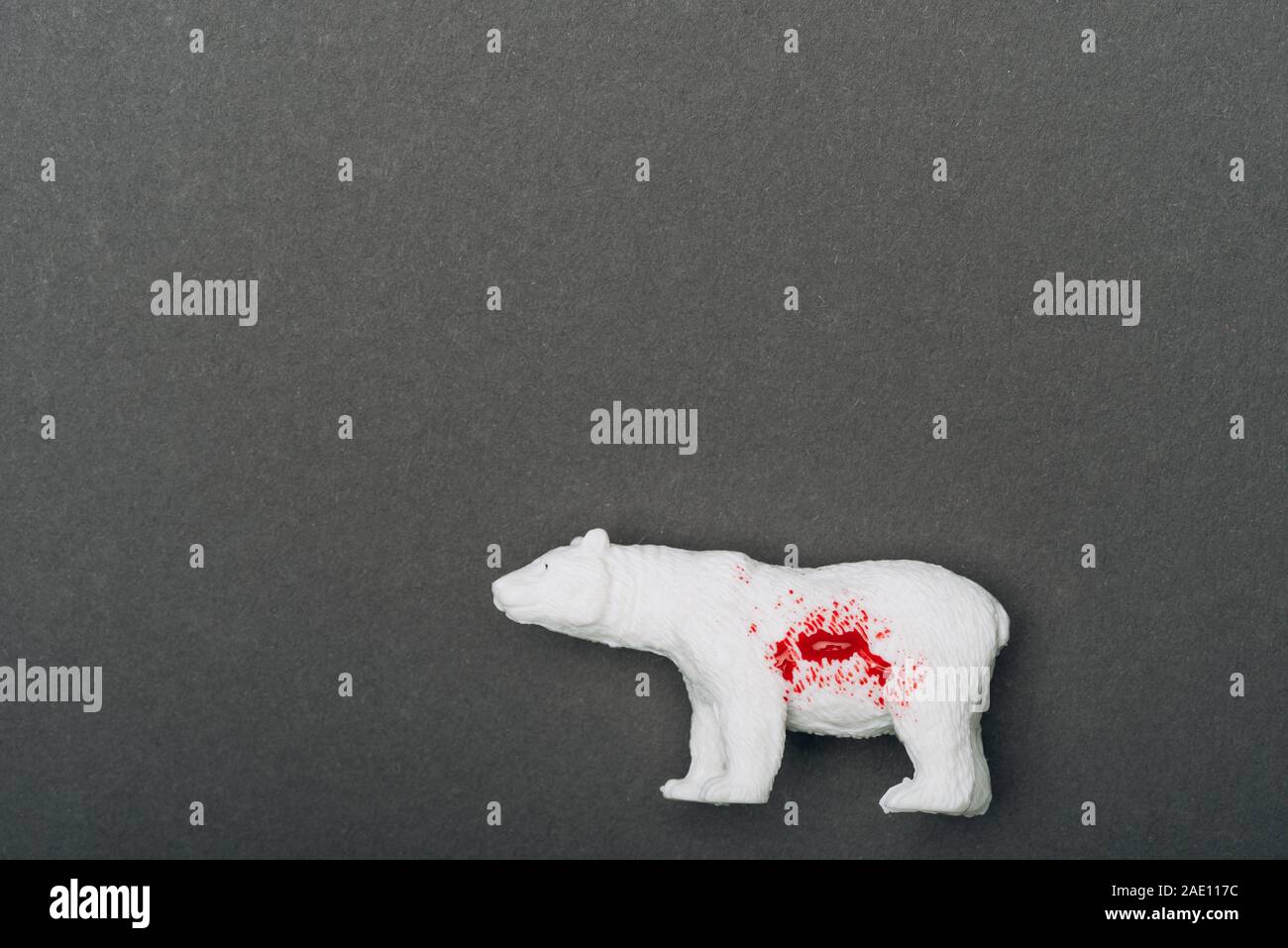 Top view of white toy bear with blood on grey background, killing ...