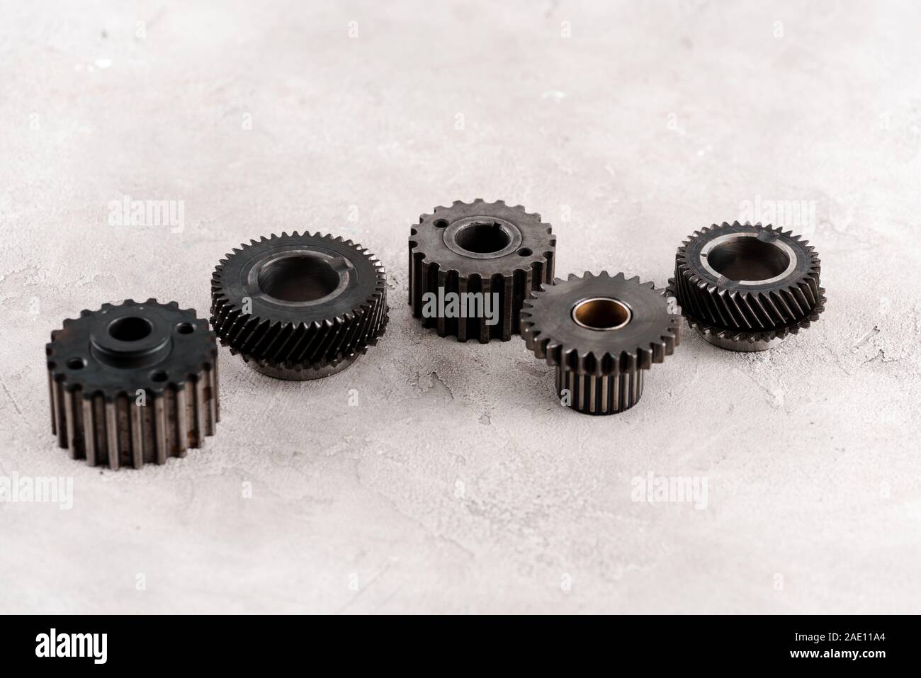 metal round gears on grey background Stock Photo - Alamy