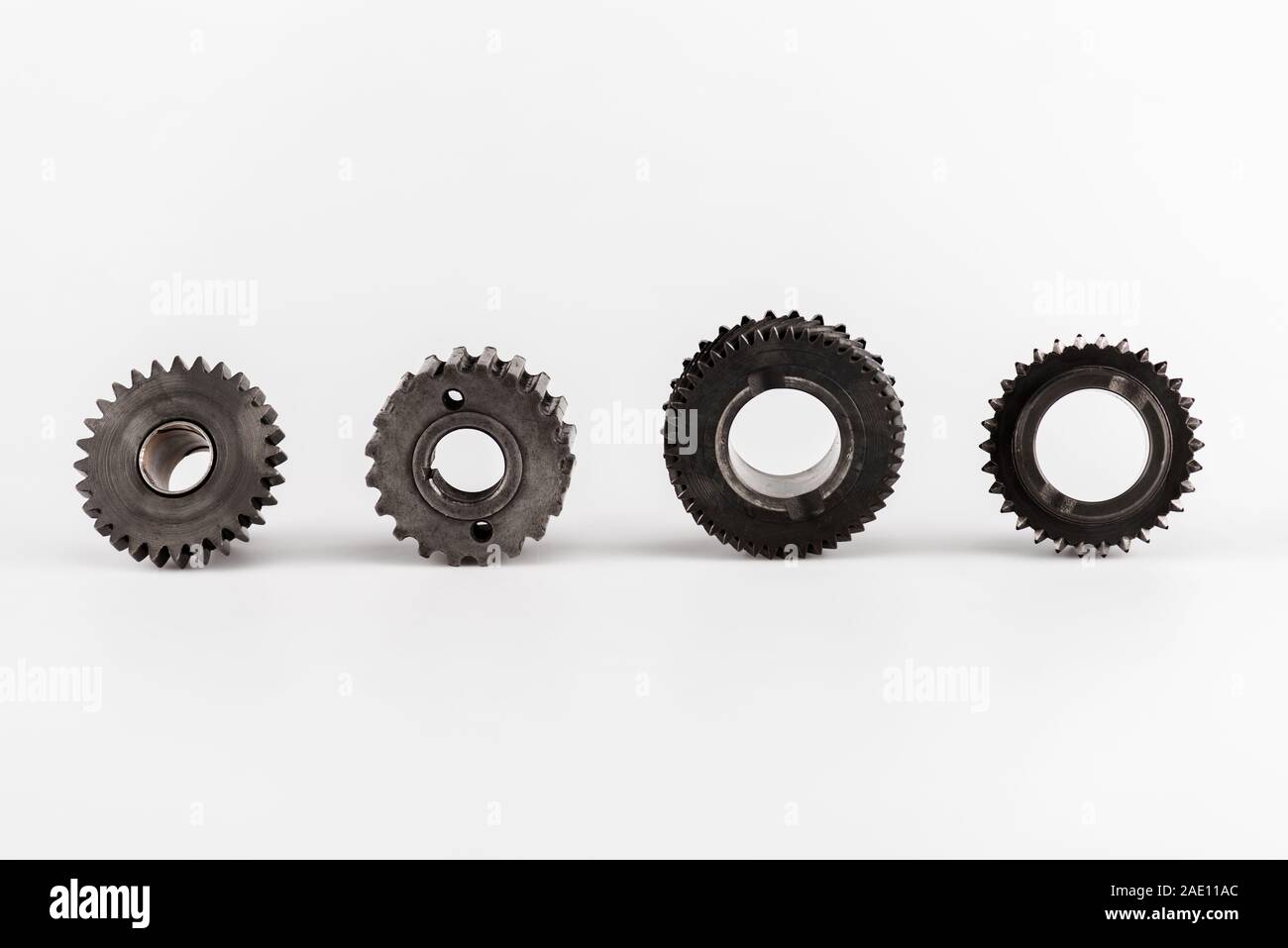 metal round gears in row on white background Stock Photo - Alamy