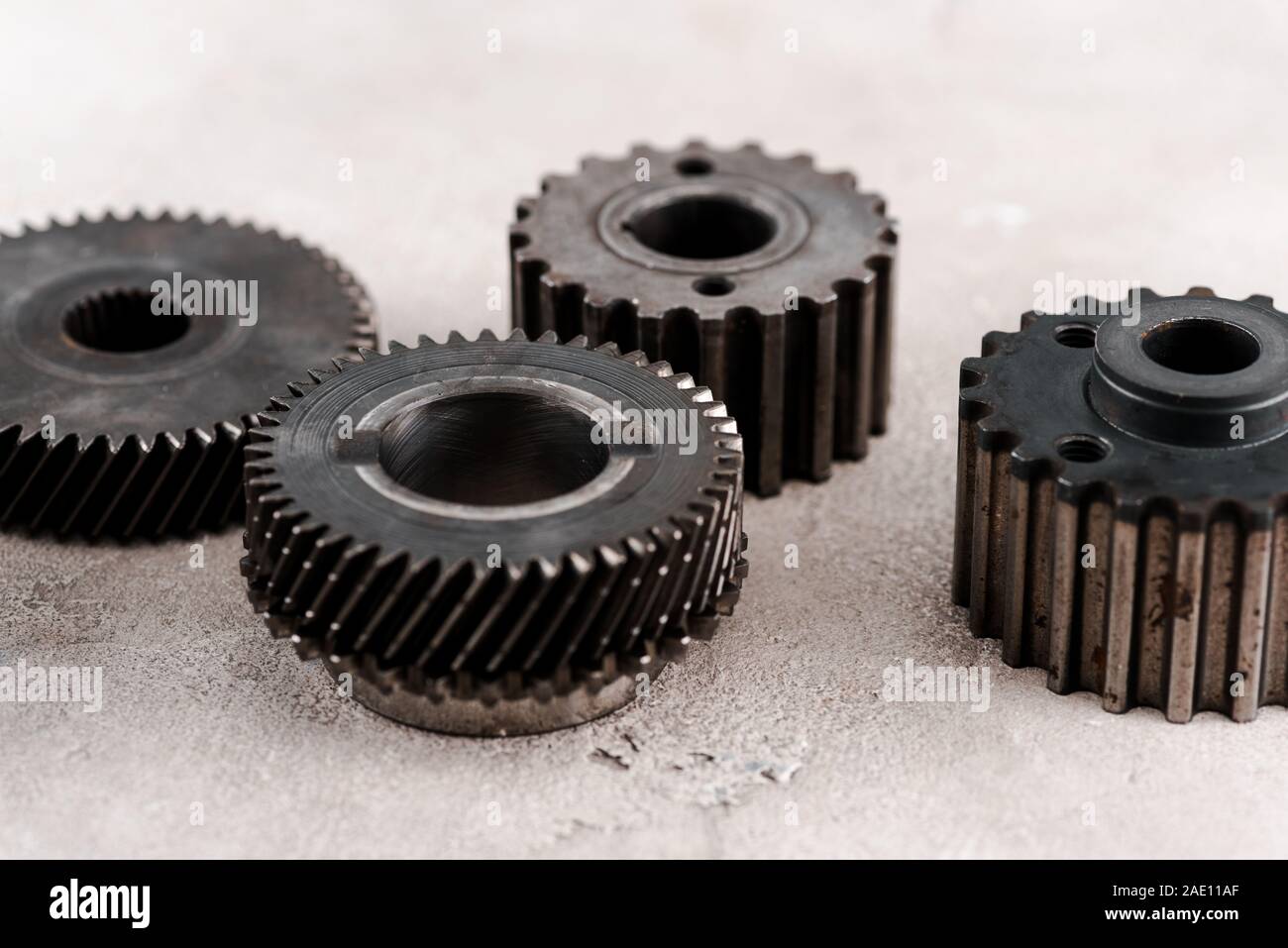 metal round gears on grey background Stock Photo - Alamy