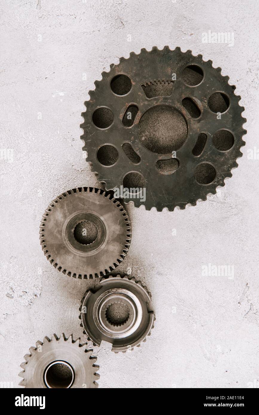 top view of aged metal round gears on grey background Stock Photo - Alamy