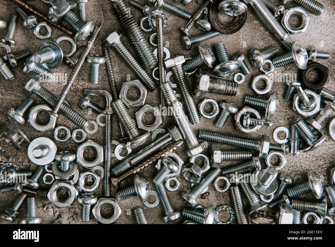 top view of metal screws and nails scattered on grey background Stock ...