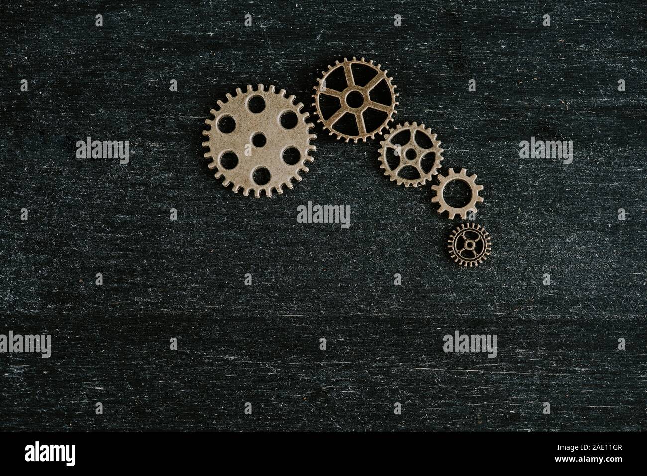 top view of retro metal gears on dark wooden background with copy space ...