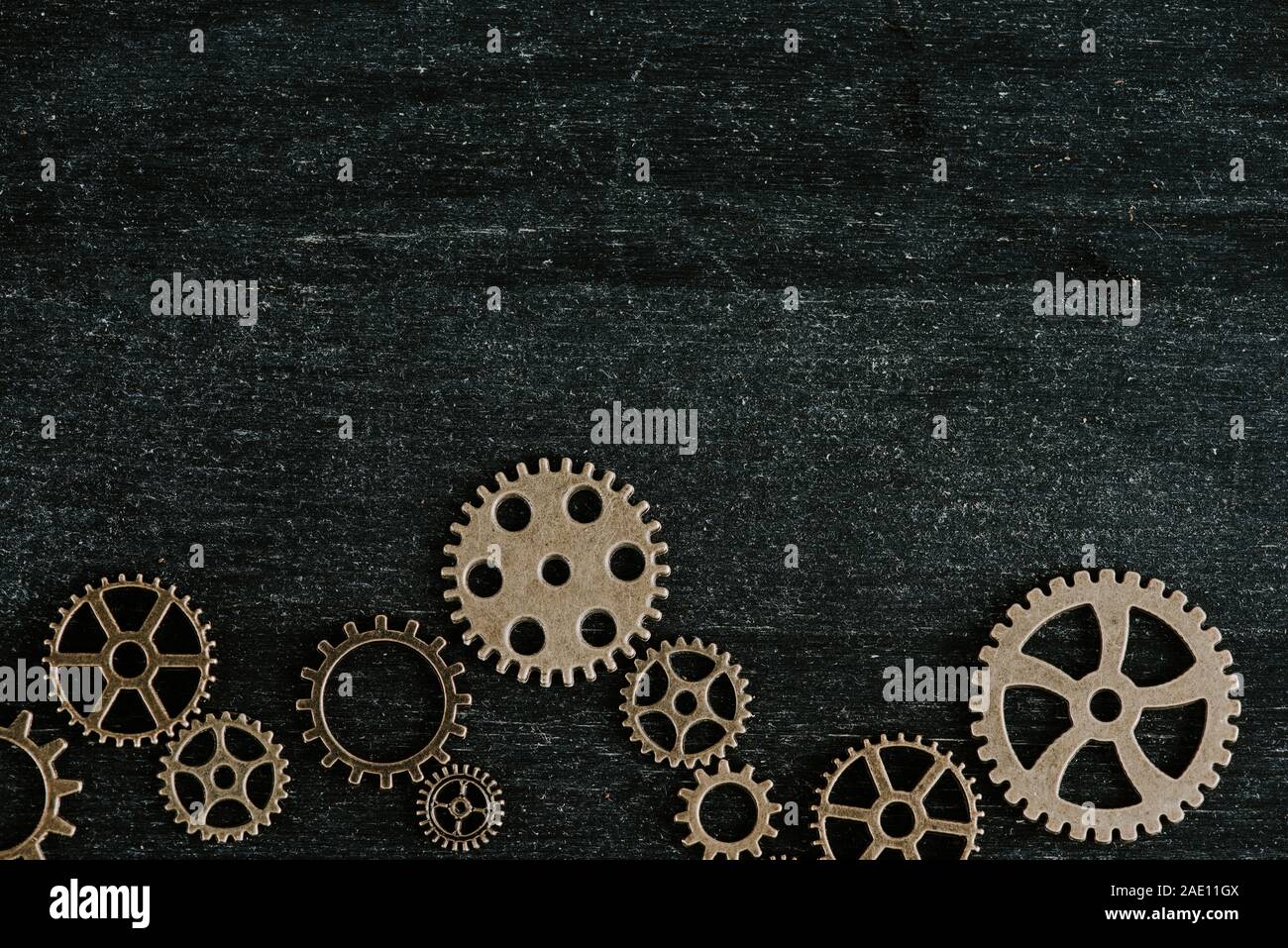 top view of retro metal gears on dark wooden background with copy space ...