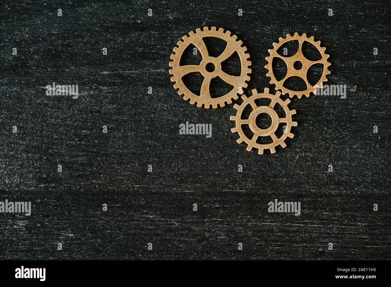 top view of vintage metal gears on dark wooden background with copy ...