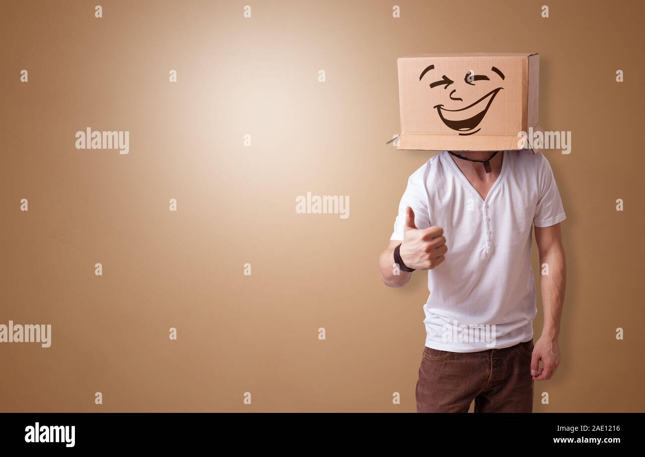 Young boy standing and gesturing with a cardboard box on his head Stock ...