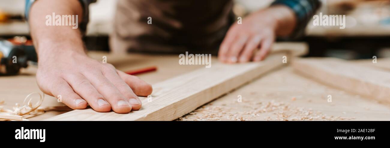 panoramic shot of carpenter touching wooden plank Stock Photo - Alamy