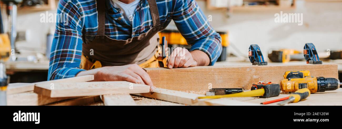 panoramic shot of carpenter touching wooden dowel Stock Photo - Alamy