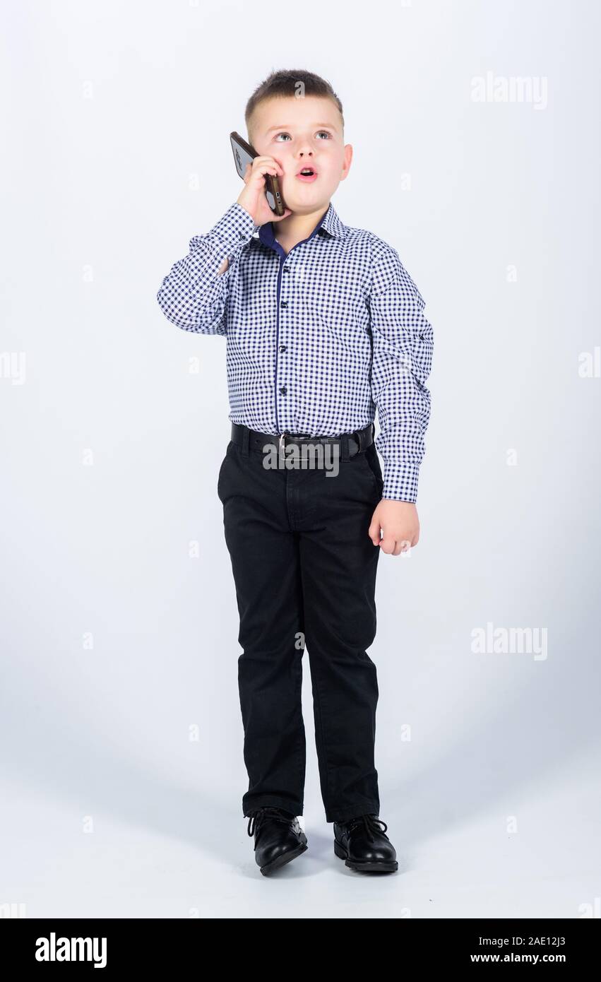 Little boy formal clothes call mobile phone. Cute boy hold smartphone ...