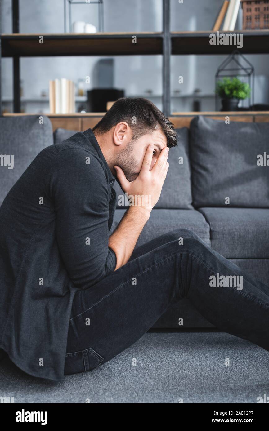 side view of man with panic attack crying in apartment Stock Photo - Alamy