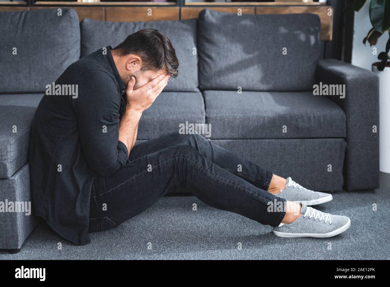 side view of man with panic attack crying in apartment Stock Photo - Alamy