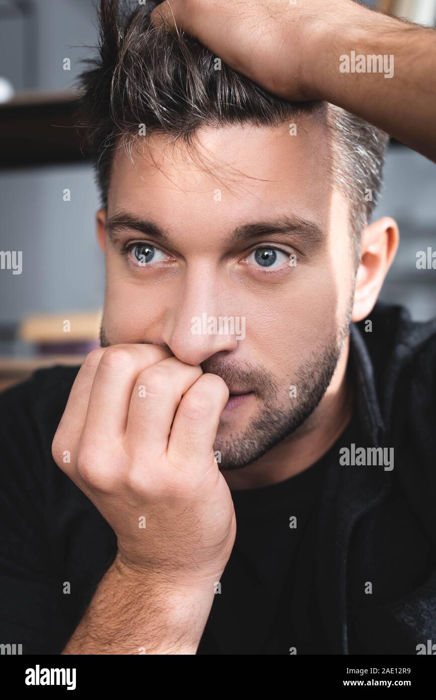handsome man with panic attack touching head in apartment Stock Photo ...