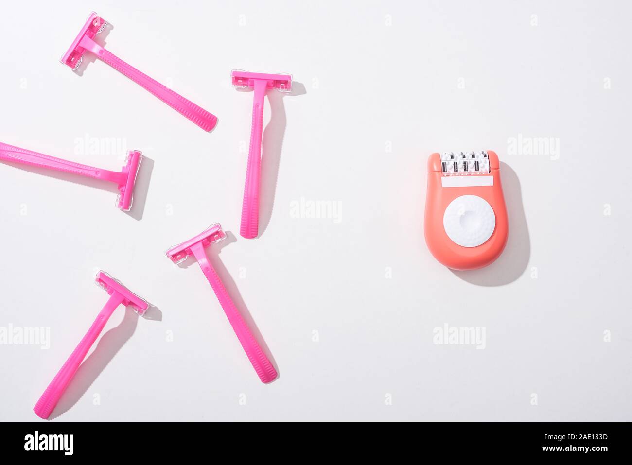 top view of female pink razors and epilator on white background Stock ...