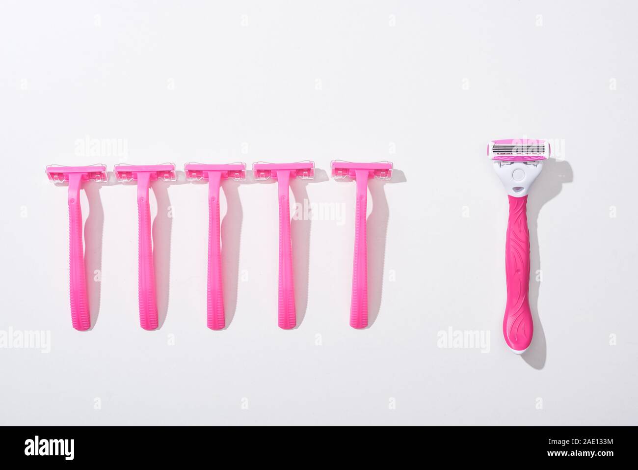 flat lay with female pink razors on white background Stock Photo - Alamy