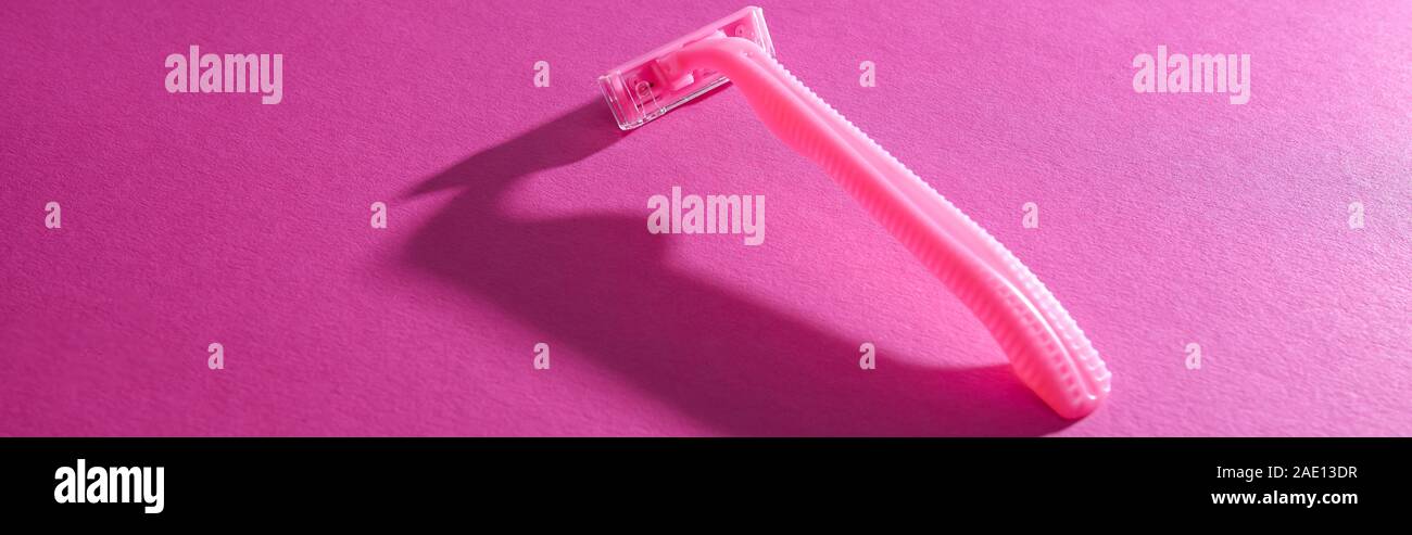 disposable feminine razor on pink background with copy space, panoramic ...