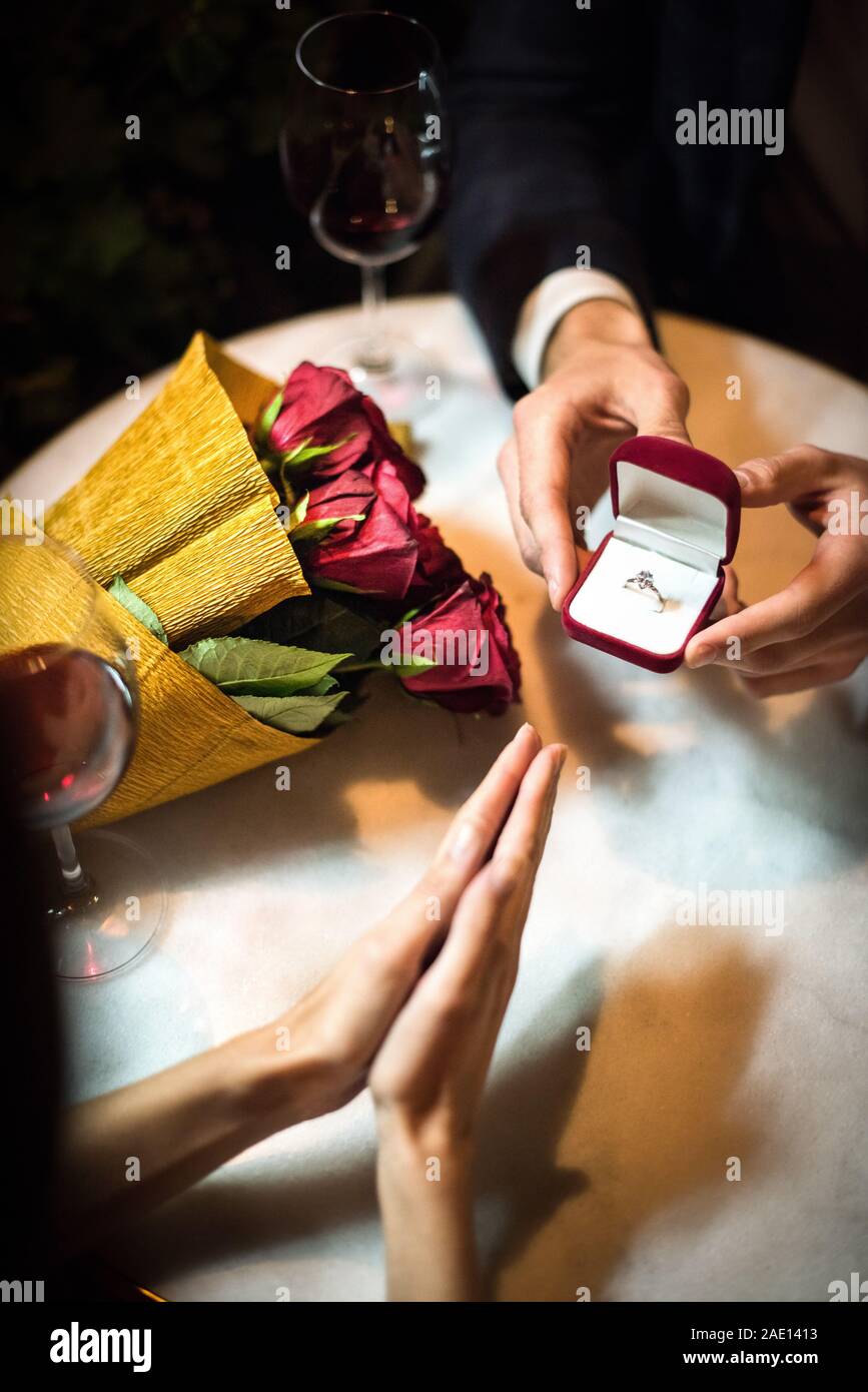 cropped view of man presenting wedding ring to girlfriend while making ...