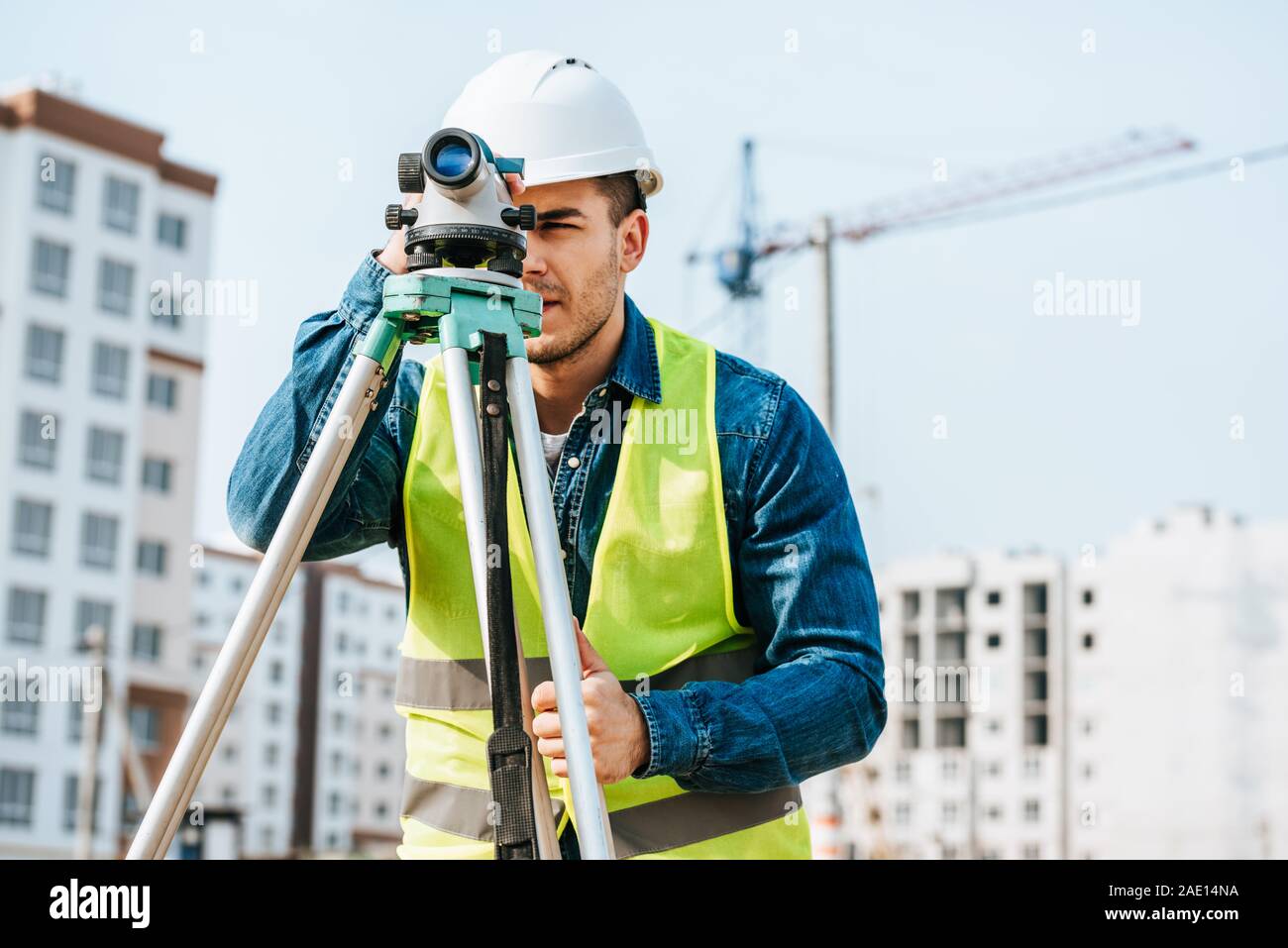Surveyor looking throughout digital level on construction site Stock ...