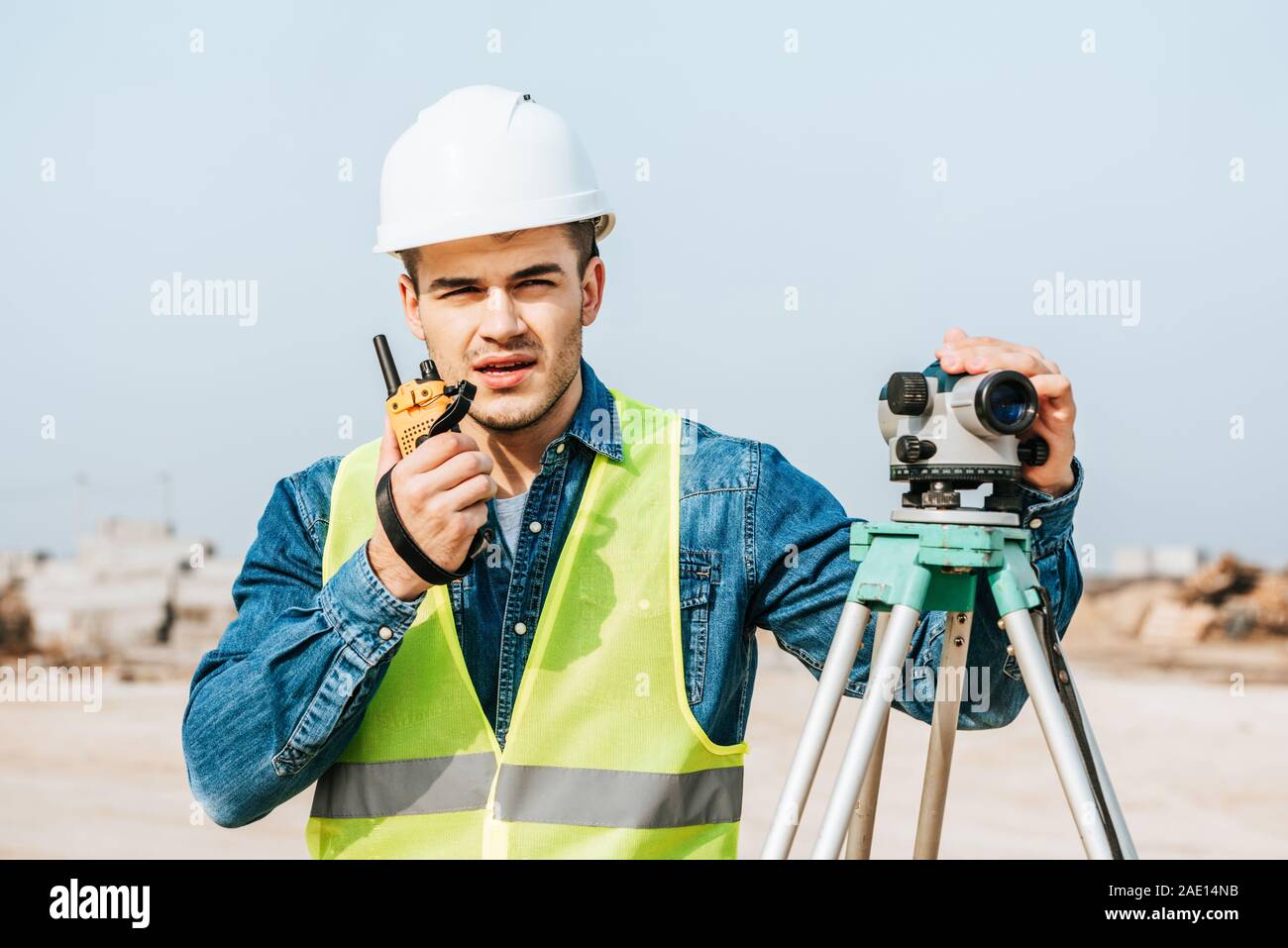 Handsome surveyor with digital level talking on radio set Stock Photo ...