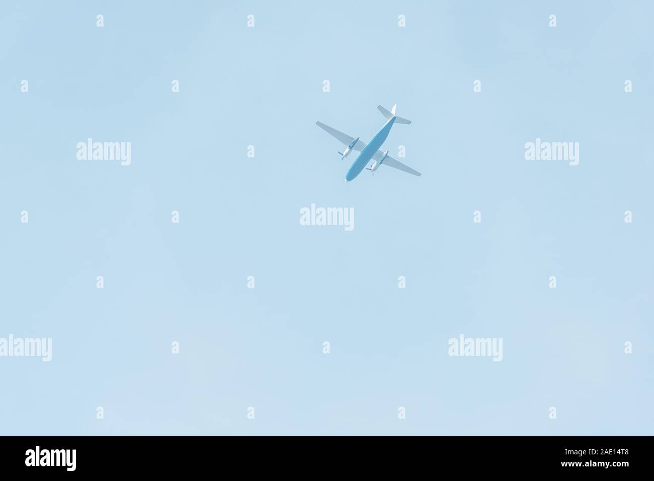 Bottom view of airplane with blue sky at background Stock Photo - Alamy
