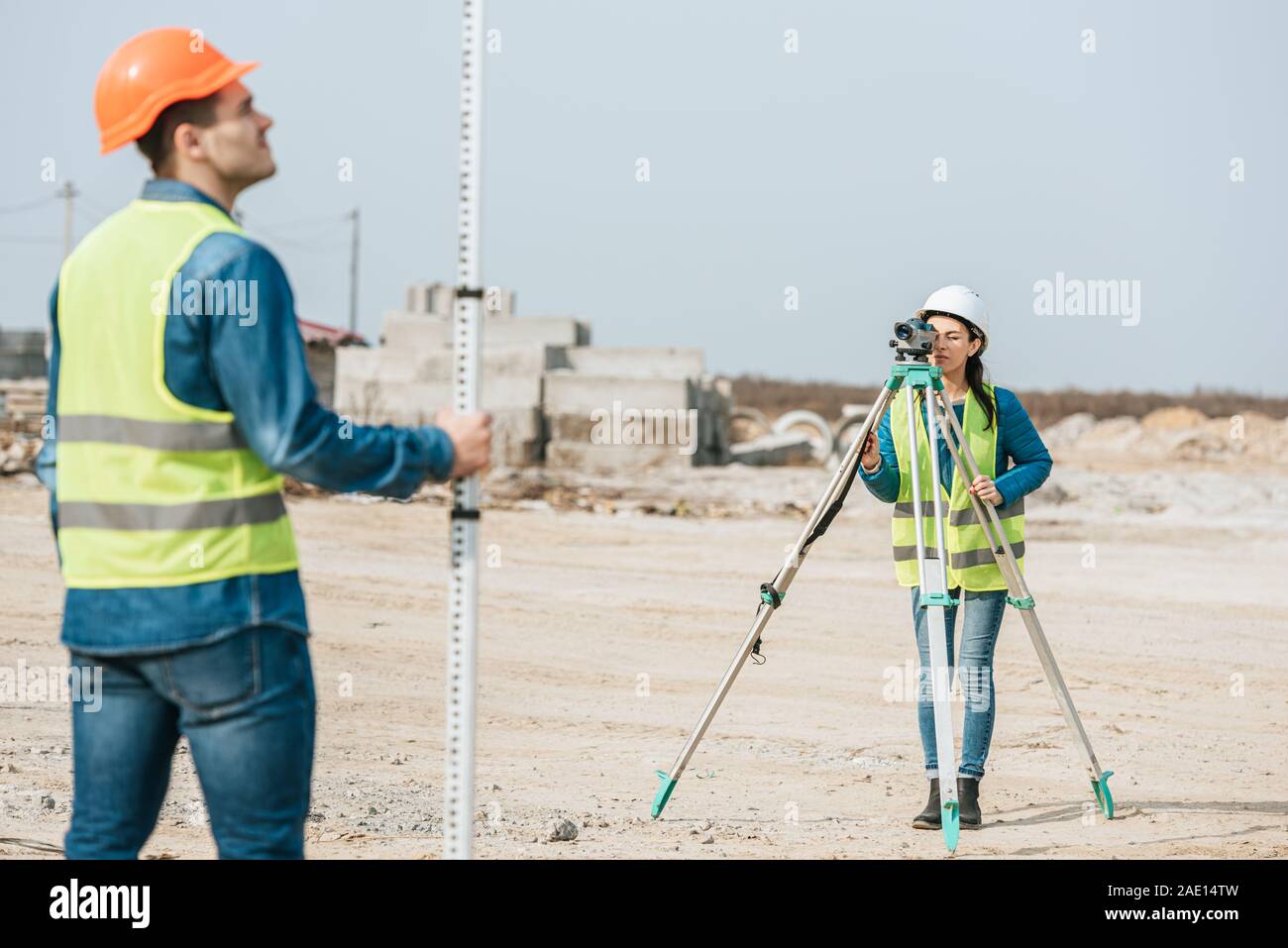Selective focus of surveyors using digital level and ruler on ...