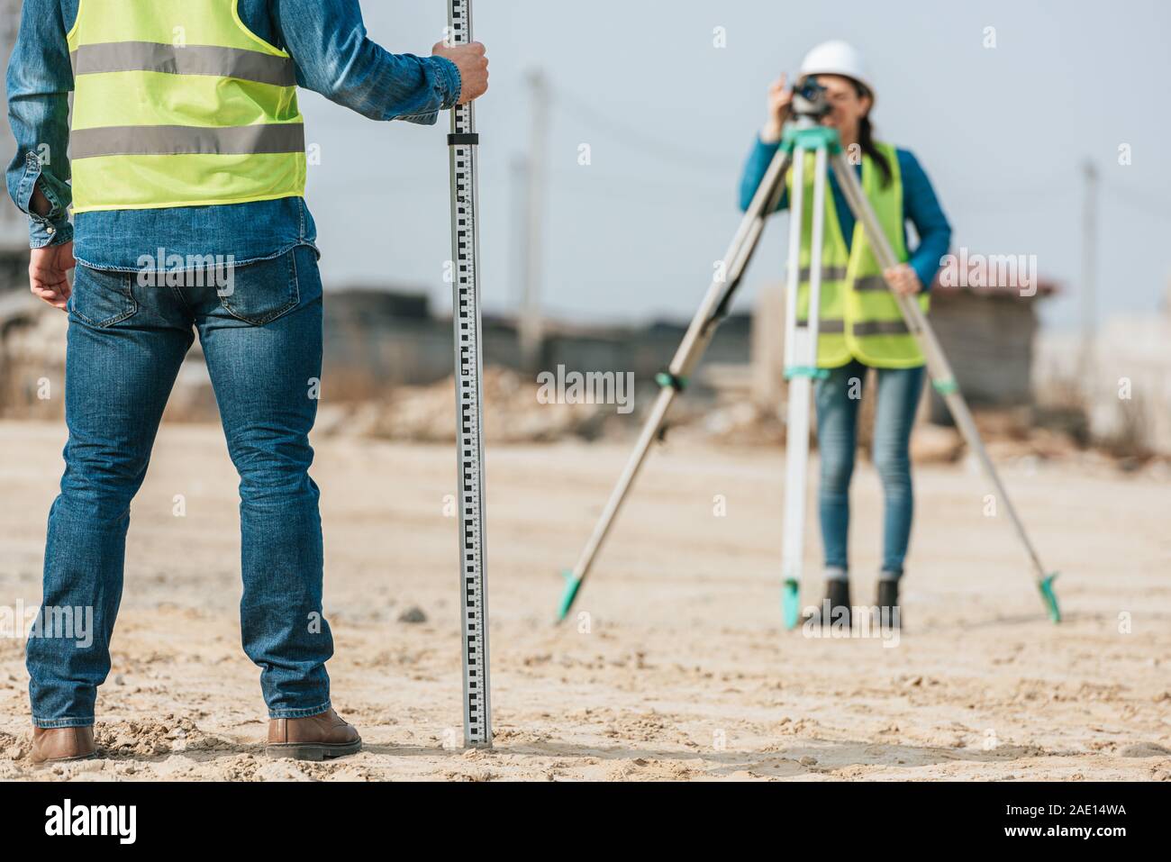 Selective focus of surveyors using ruler and digital level Stock Photo ...
