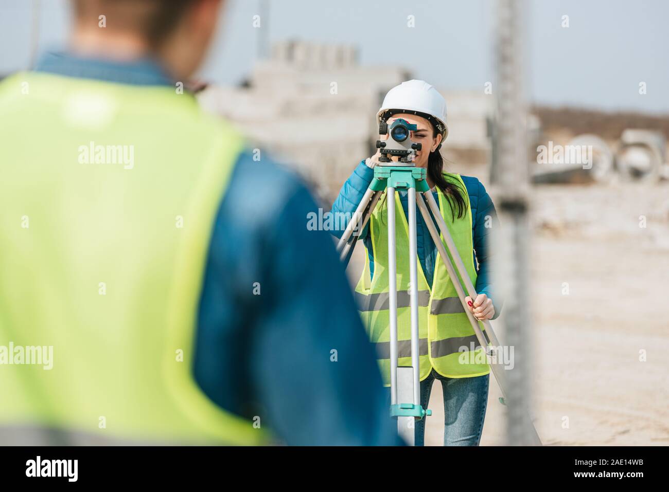 Selective focus of surveyors using digital level and survey ruler Stock ...
