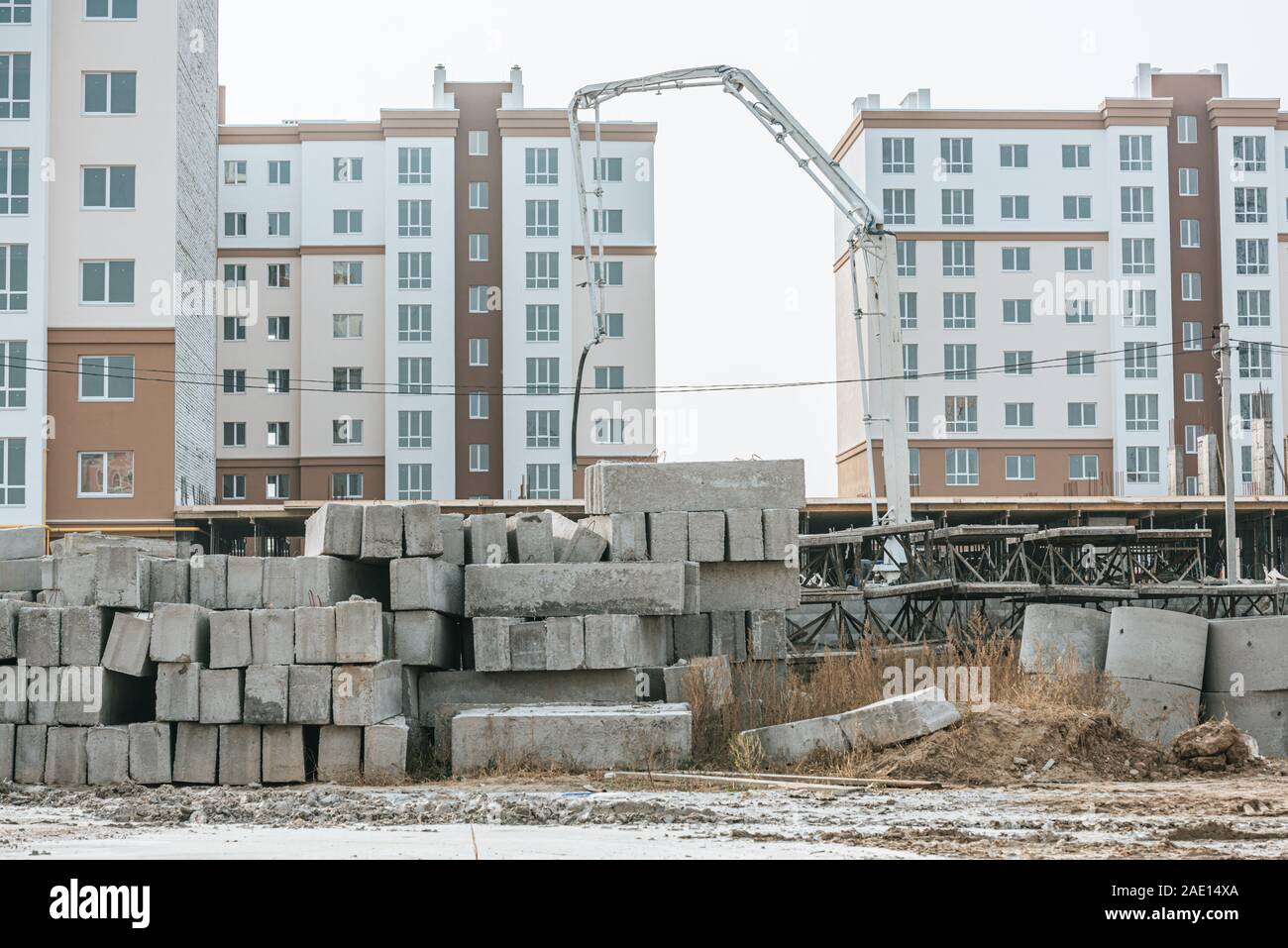 Construction site with concrete blocks and heavy machinery Stock Photo ...