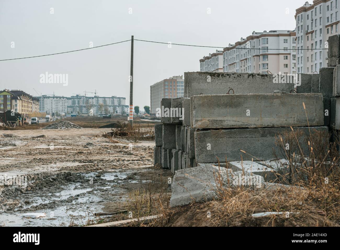 Concrete blocks on dirt road and construction site at background Stock ...