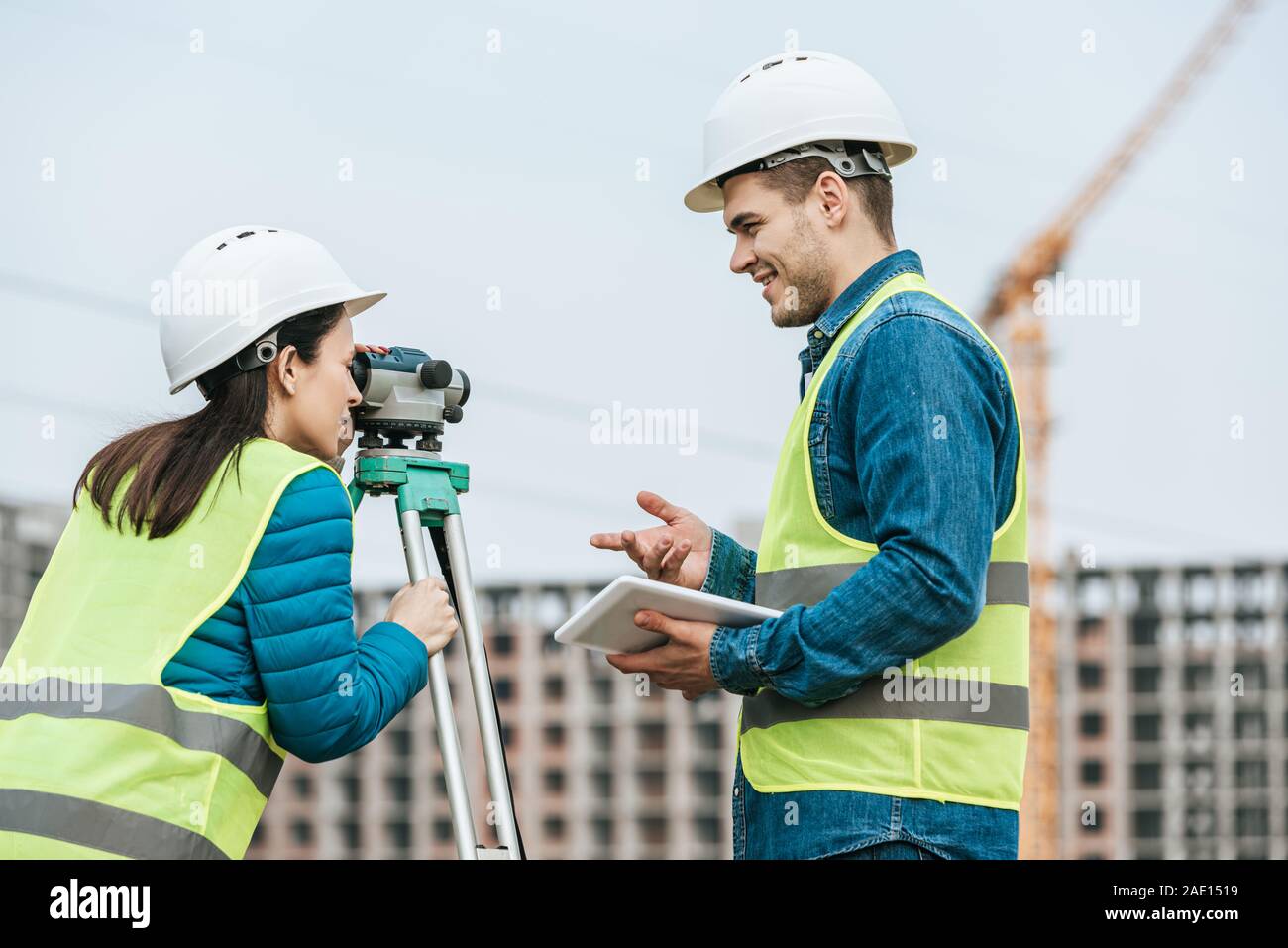 Surveyors using tablet and digital level on construction site Stock ...