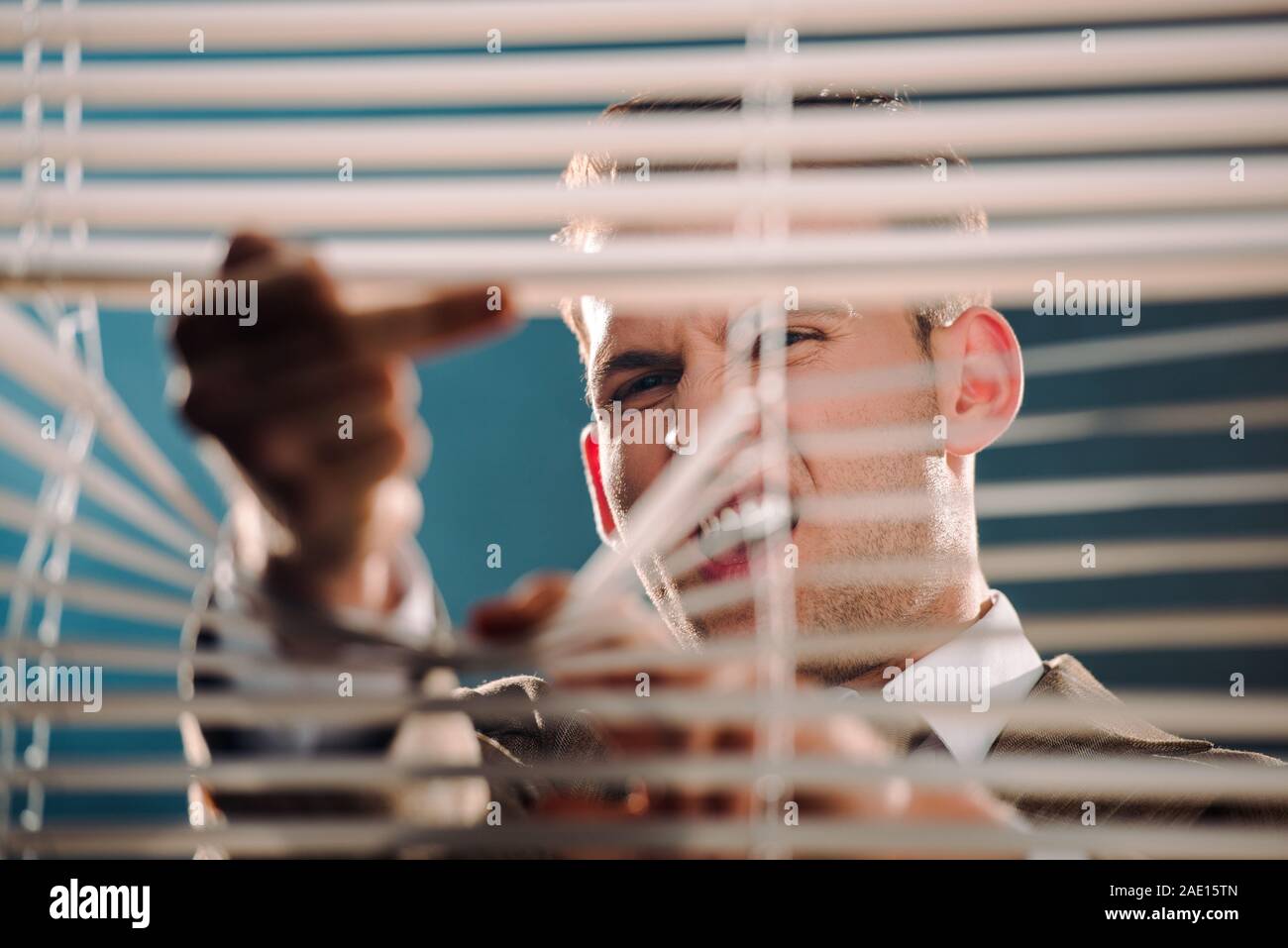 selective focus of emotional gangster showing middle finger through ...