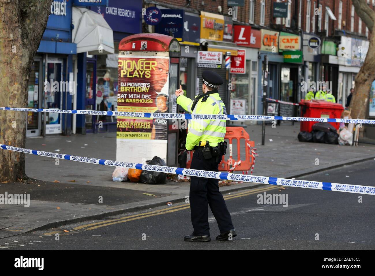 A police officer reacts at the crime scene outside Turnpike Lane tube ...