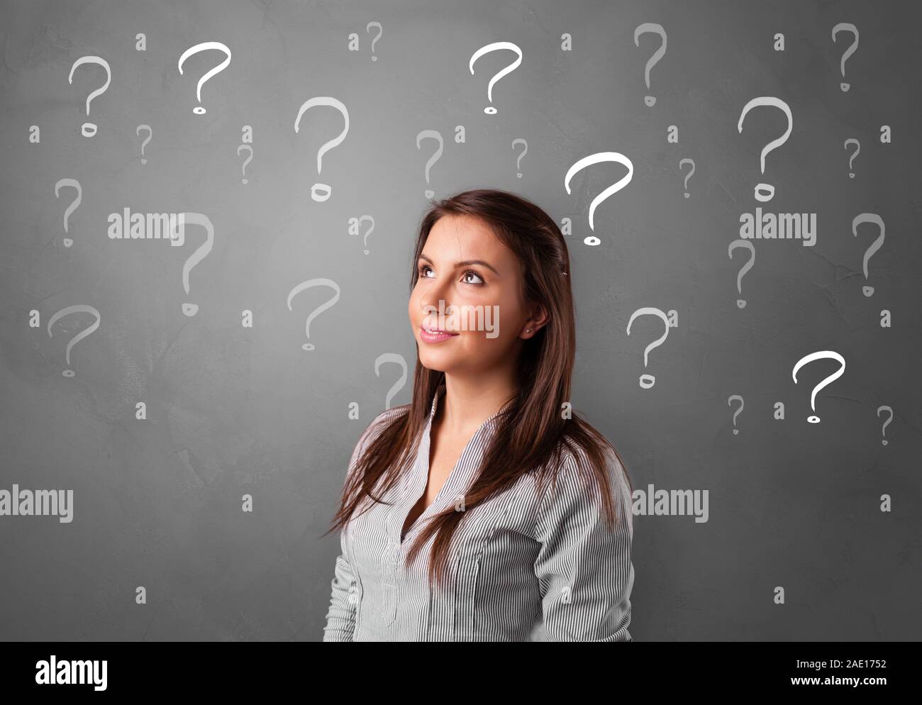 Person with question marks around face Stock Photo - Alamy