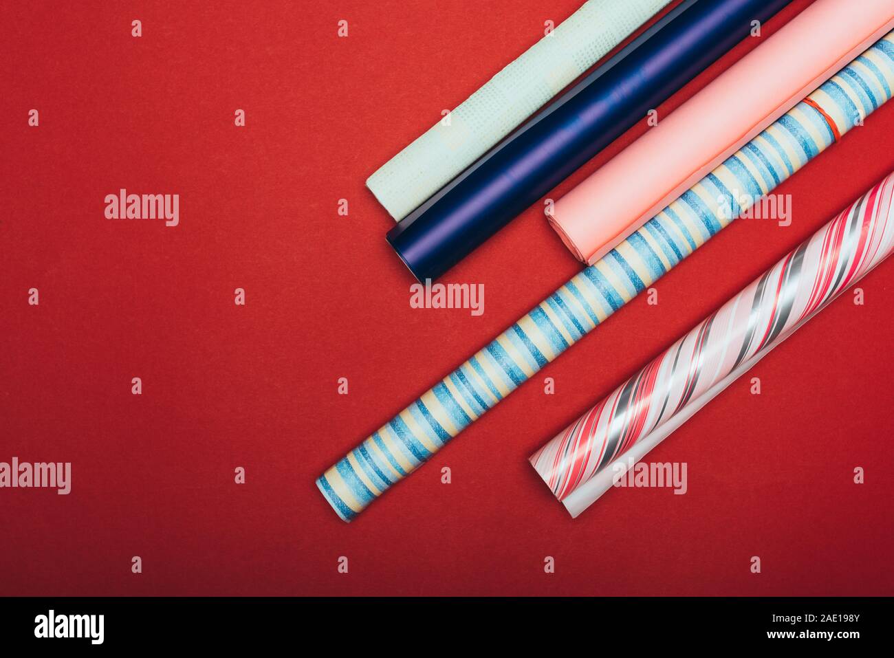 top view of wrapping paper rolls on red Stock Photo - Alamy