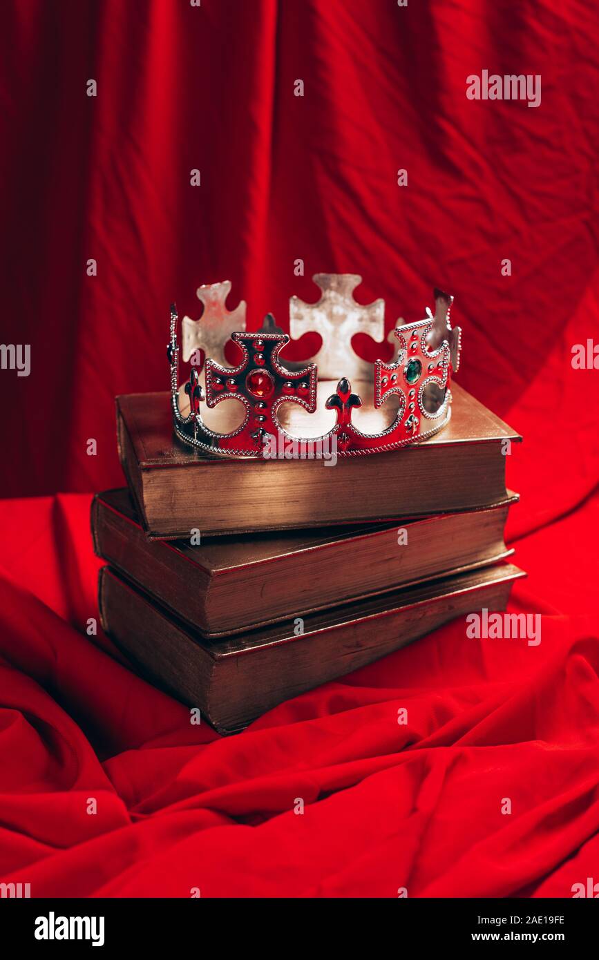 ancient silver crown with gemstones on books on red cloth Stock Photo ...