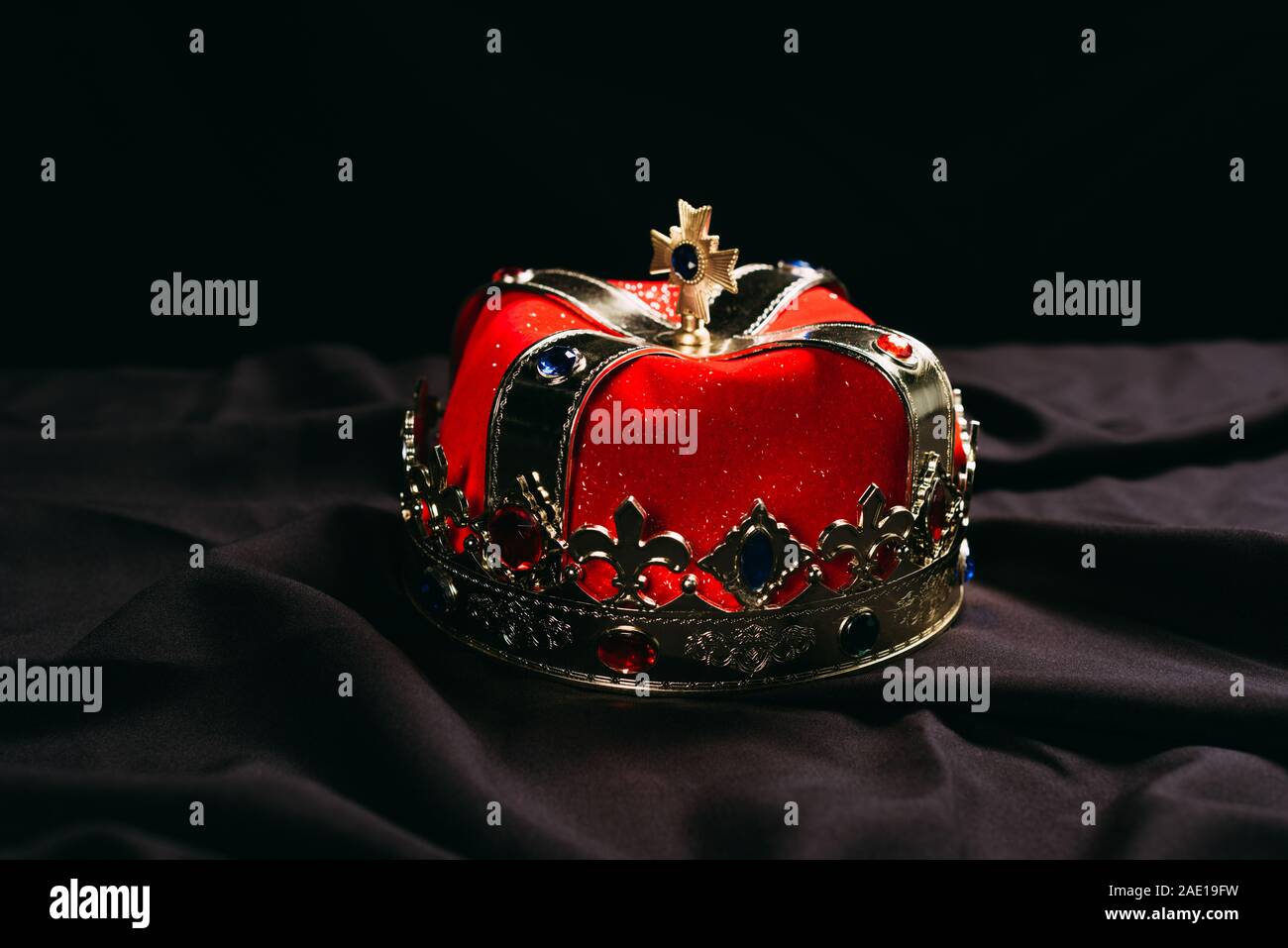 ancient red golden crown with gemstones on black cloth Stock Photo - Alamy