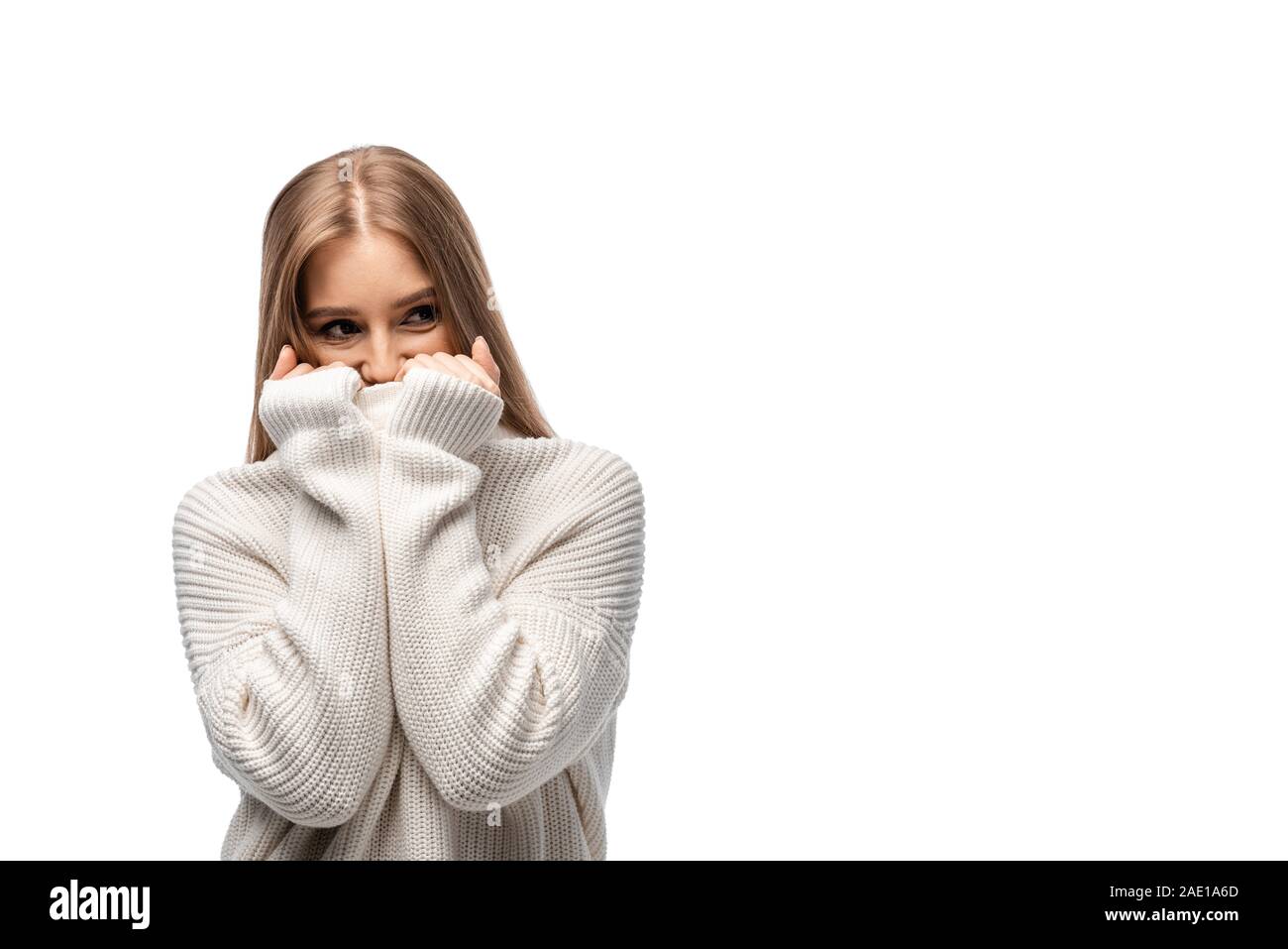 happy cold young woman in white sweater, isolated on white Stock Photo ...